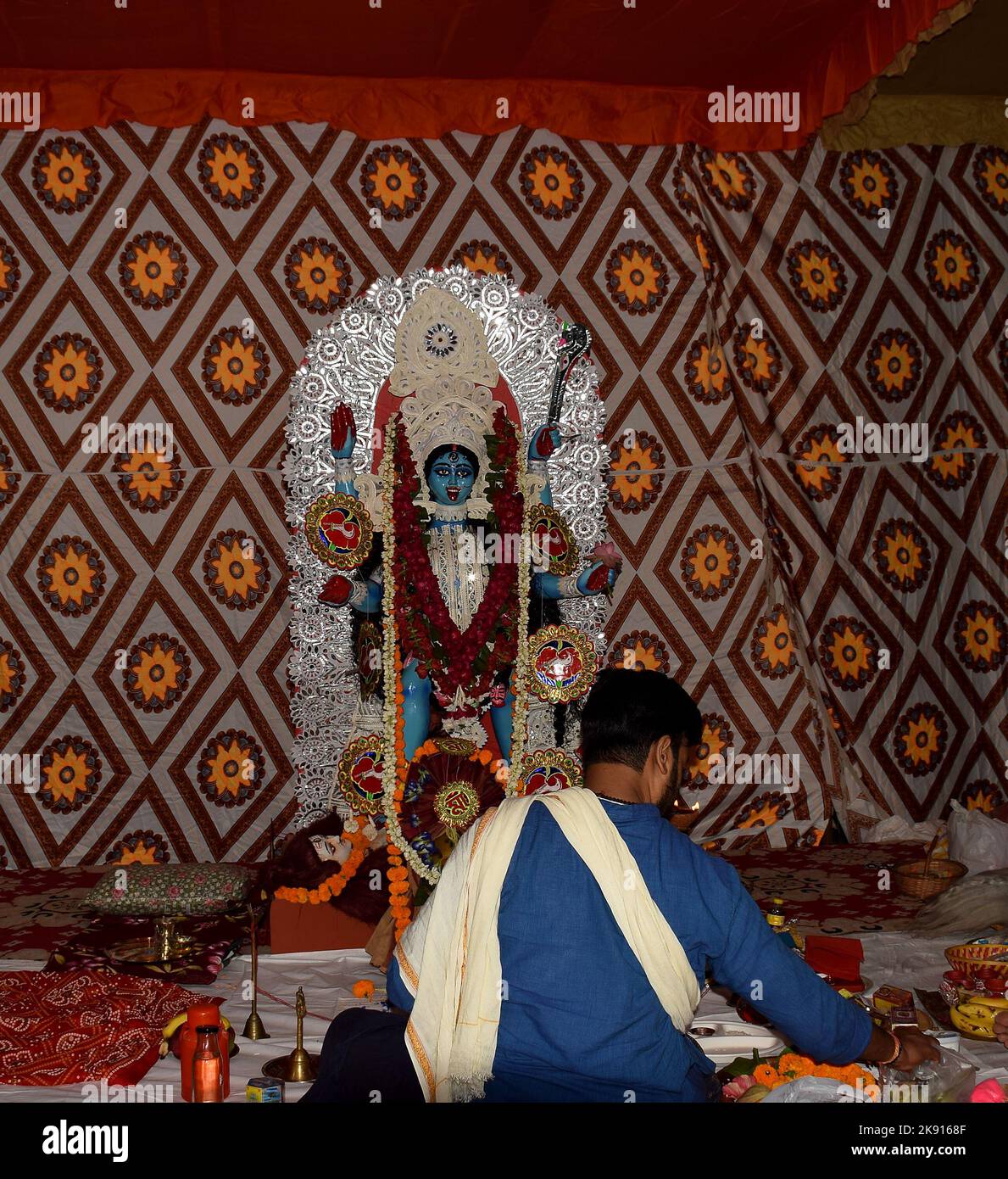 Back shot of Indian priest or purohit doing Kali Puja in India Stock ...