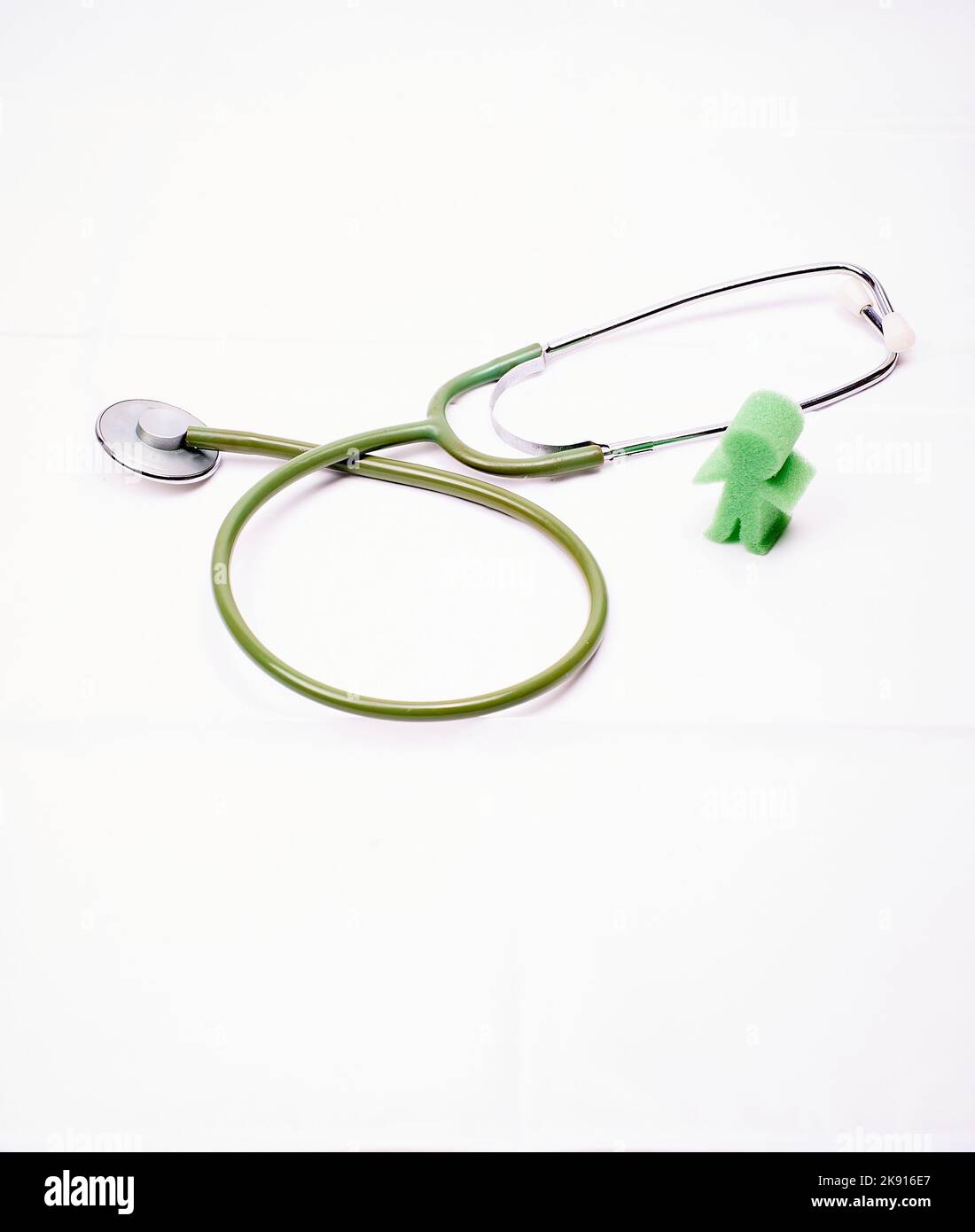 A vertical shot of a stethoscope sensor with a green human-shaped ...