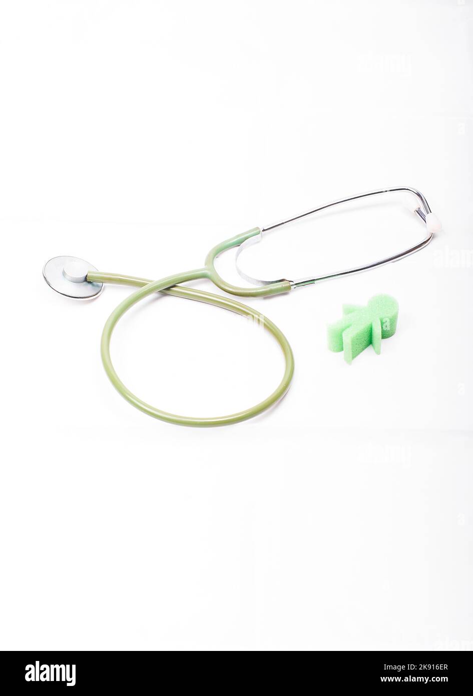 A vertical shot of a stethoscope sensor with a green human-shaped ...