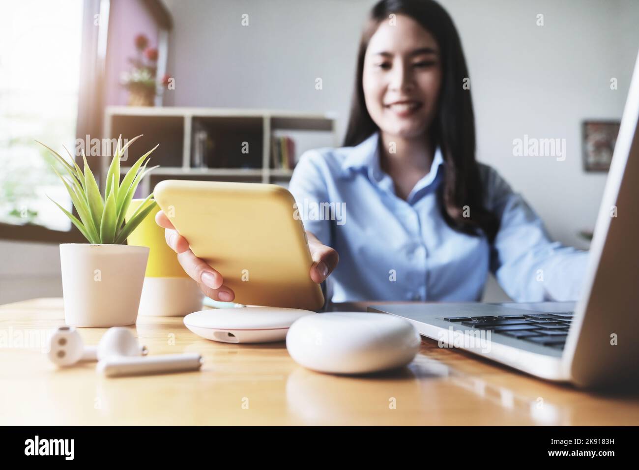 focus Female hand holding Smartphone to Charging at Wireless fast ...