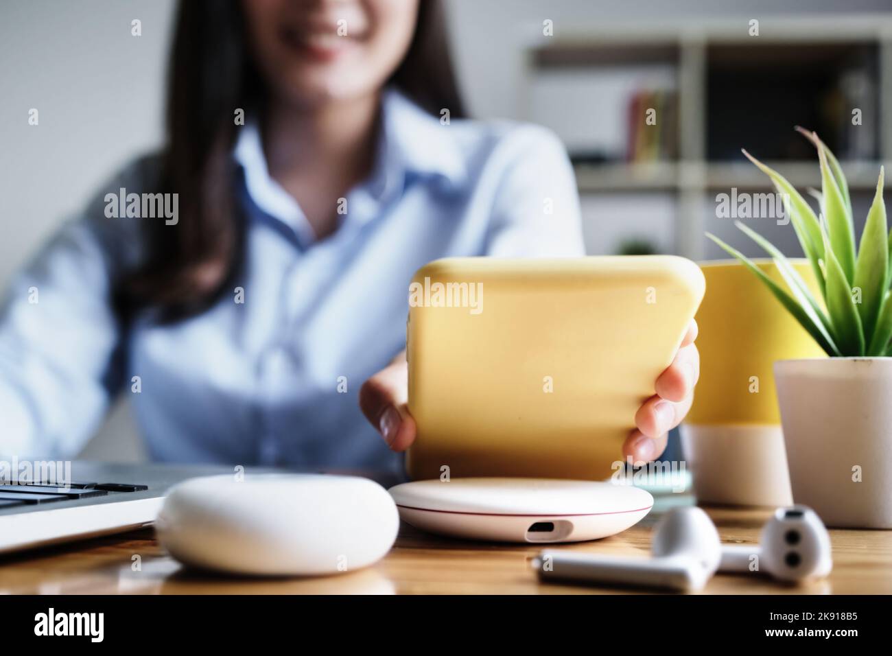 focus Female hand holding Smartphone to Charging at Wireless fast ...