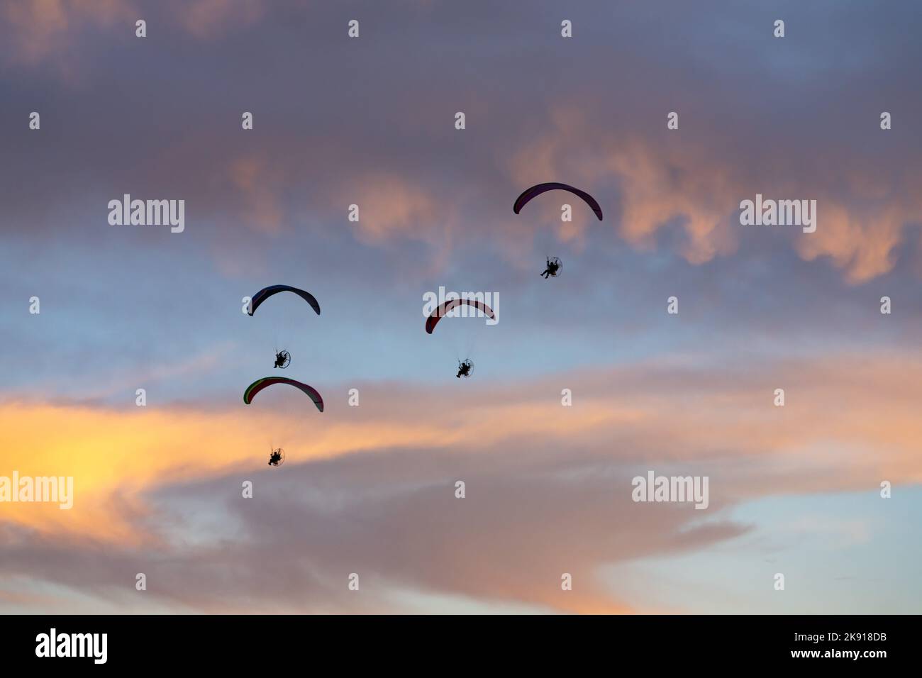 Four powered paragliders flying at sunset near Hanksville, Utah Stock ...