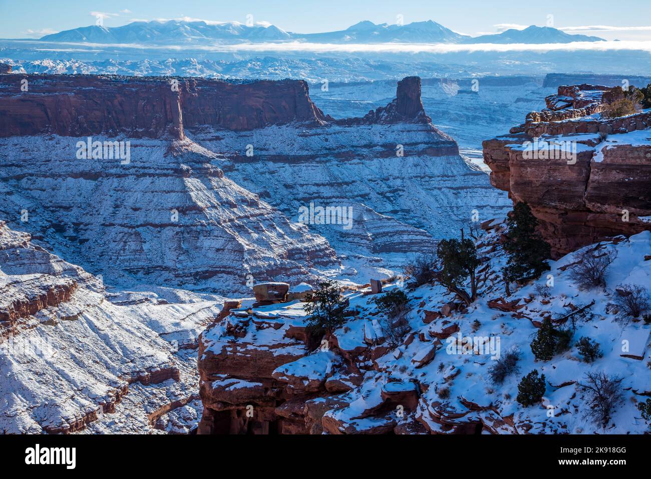 A Wingate sandstone tower in front of the La Sal Mountains with snow ...