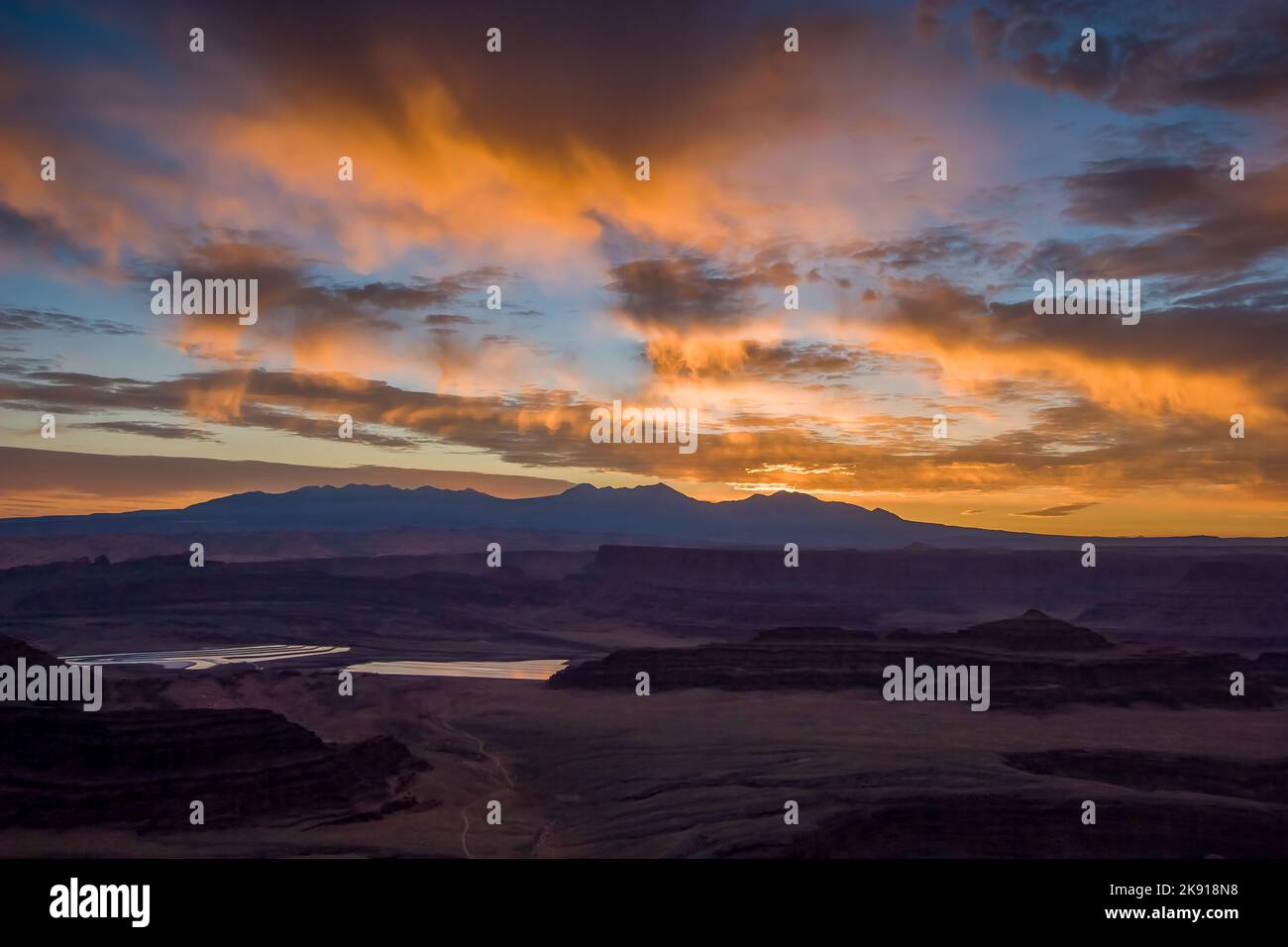 Colorful sunrise clouds over the La Sal Mountains and the Shafer Basin ...