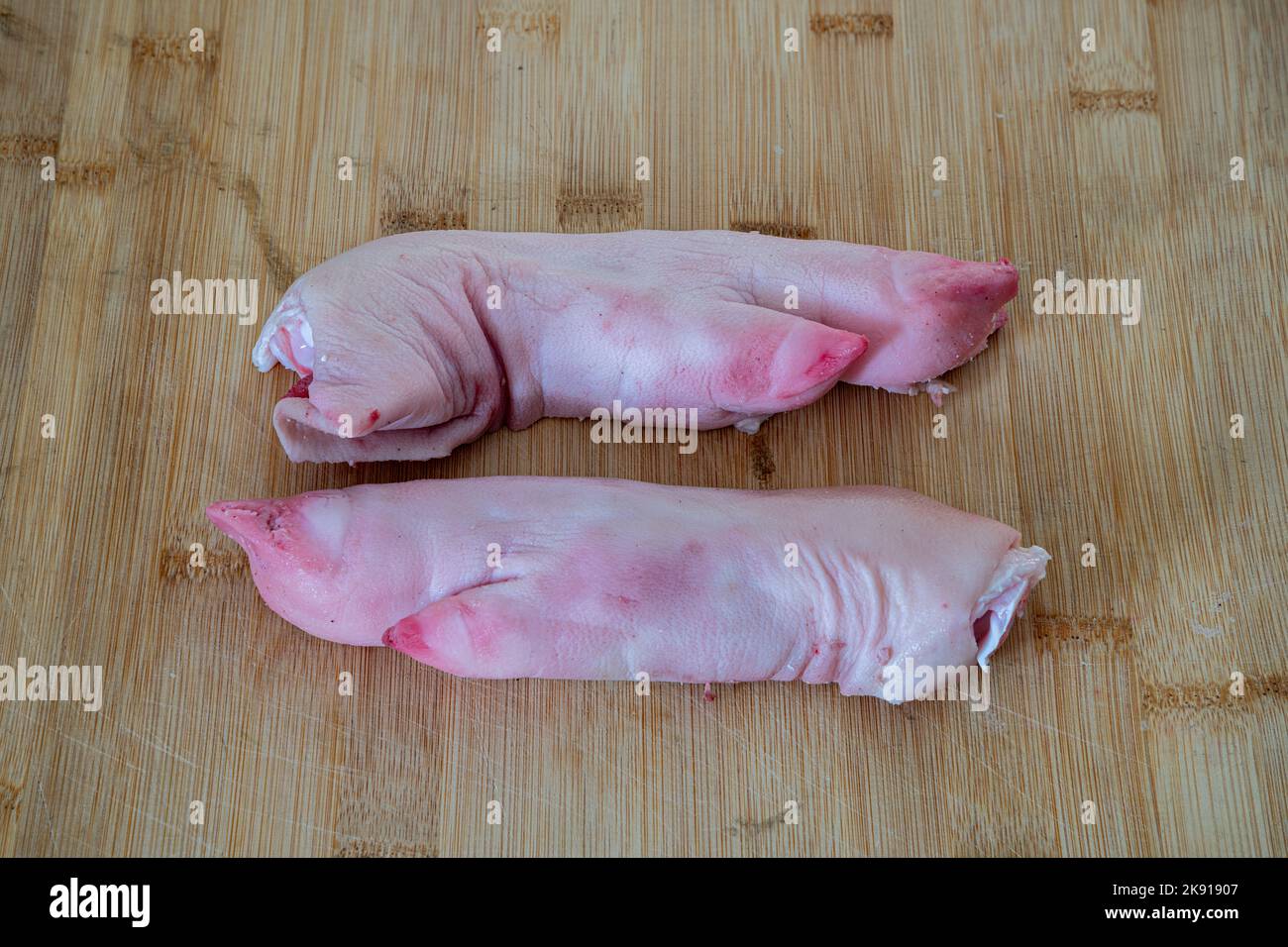 Raw pork's feet ready to be cooked on wooden cutting board Stock Photo ...