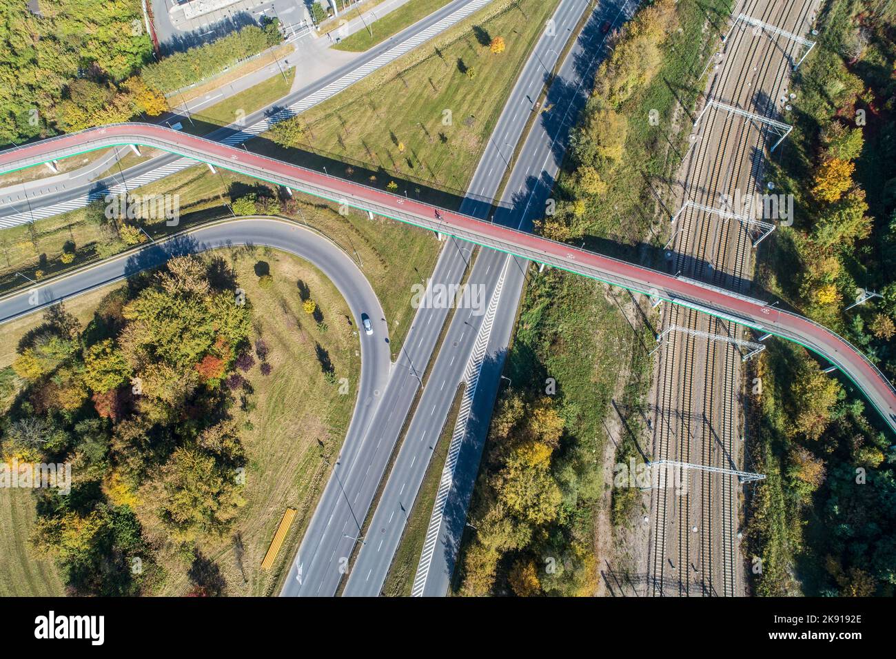 Footbridge with cycle path and pedestrian walkway over a city highway ...