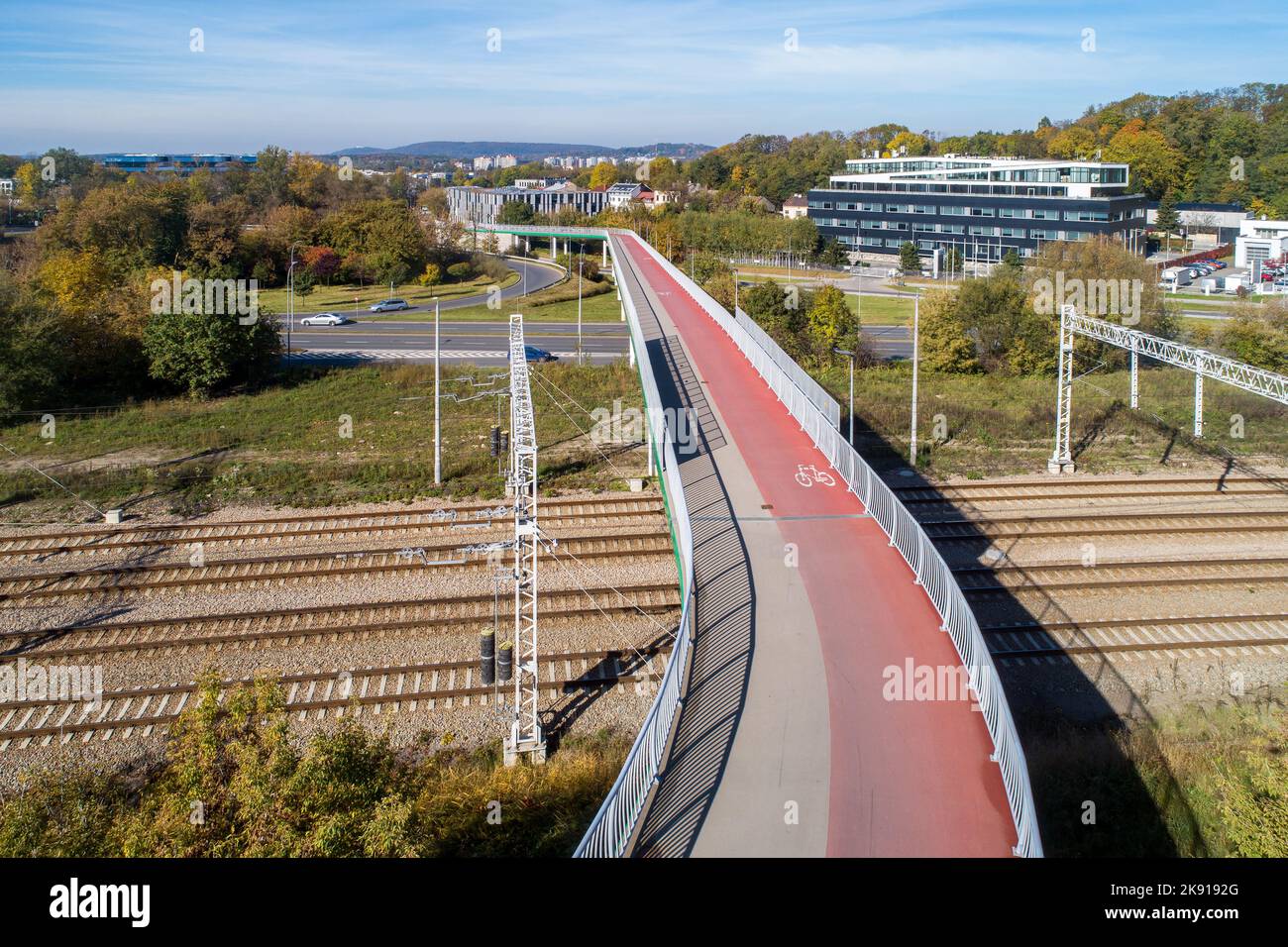 Footbridge with cycle path and pedestrian walkway over railway and city ...