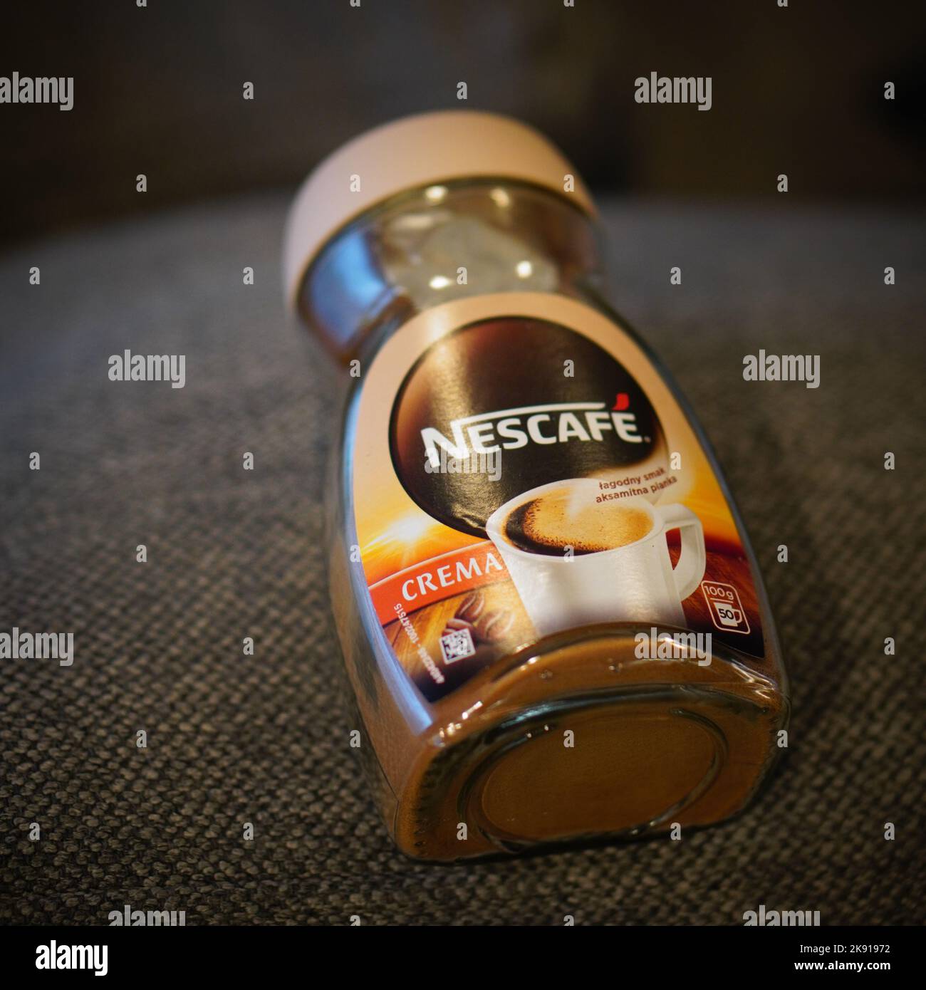 A closeup of Nescafe instant coffee Crema in a glass jar lying on a ...