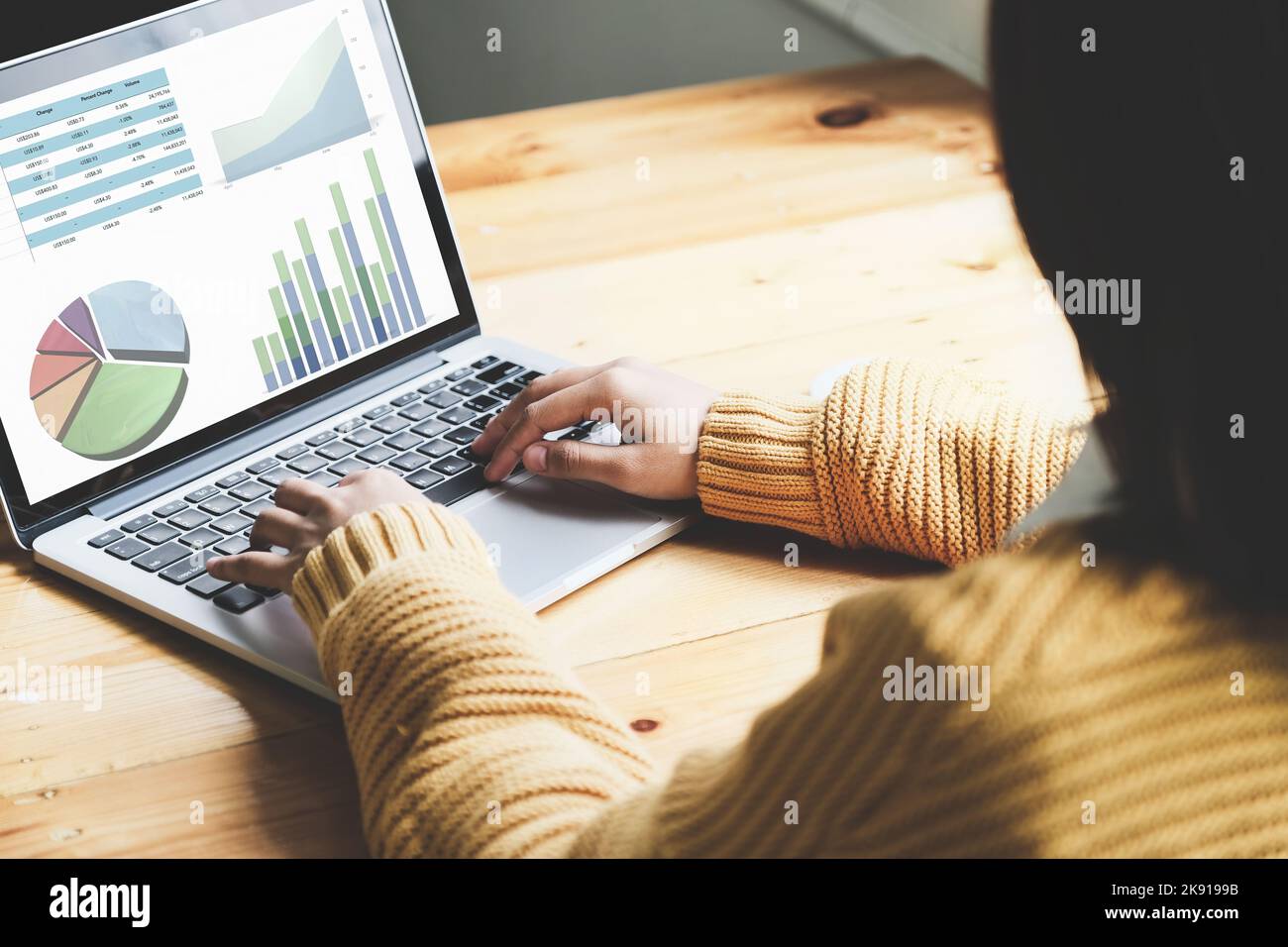 A female employee using computer to check the company's investment ...