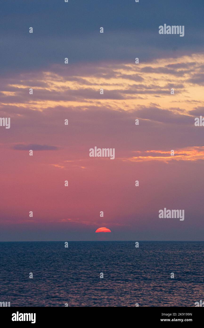 A mesmerizing view of the golden sunset over the sea Stock Photo - Alamy
