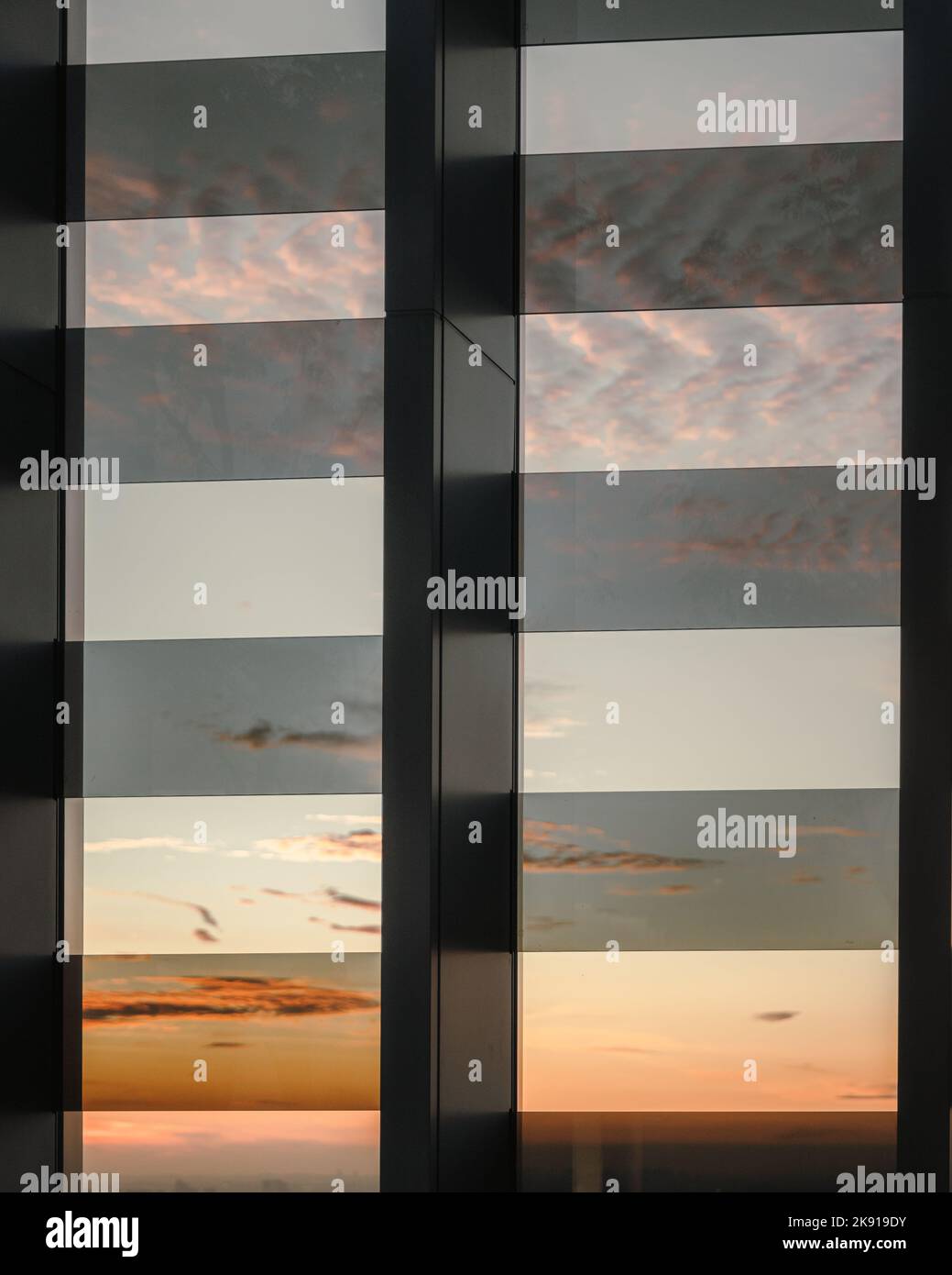 The plain glass windows with cloudy sky reflections at dusk Stock Photo ...