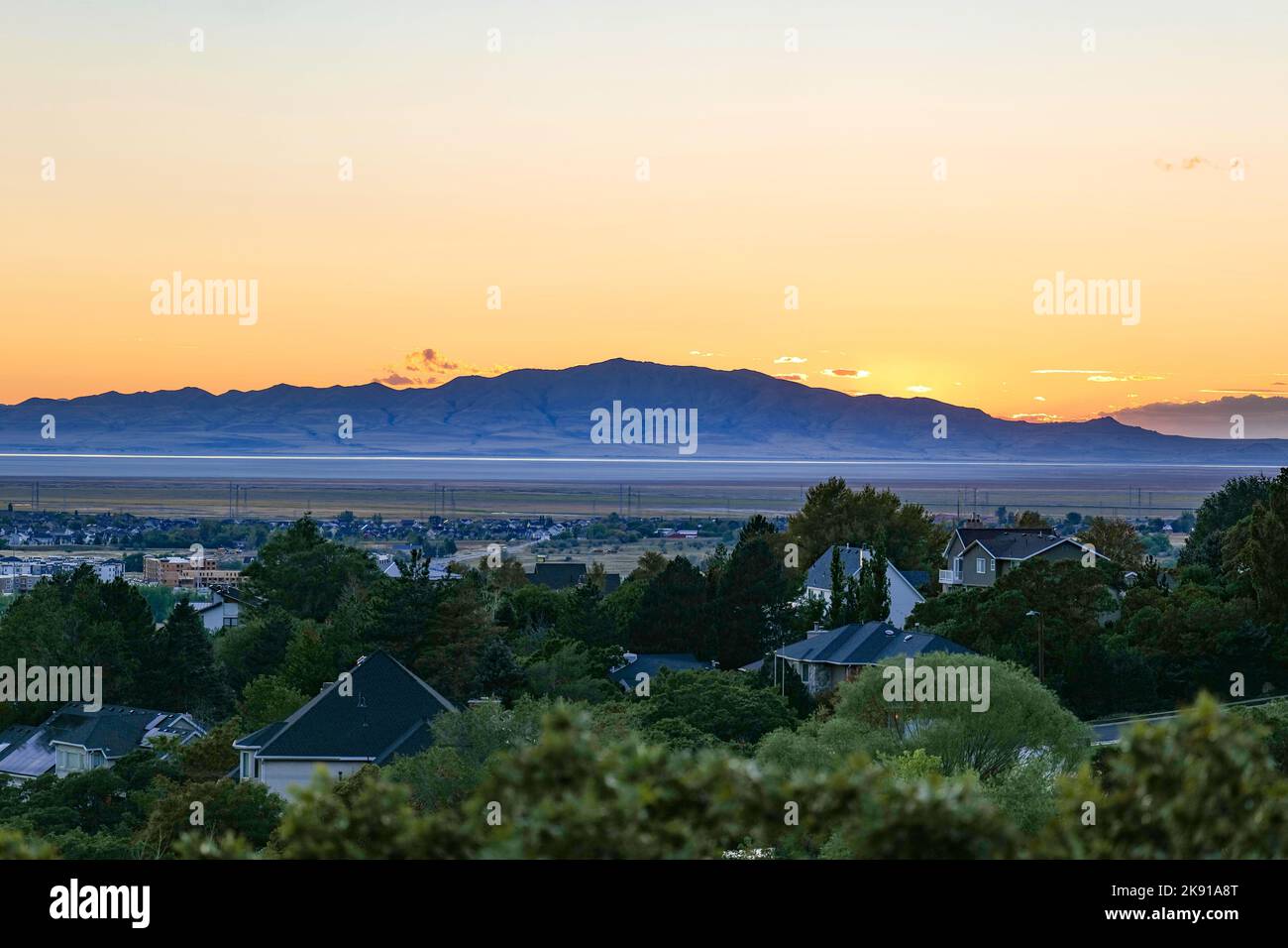 A scenic view of a sunset at the Great Salt lake with Antelope island ...