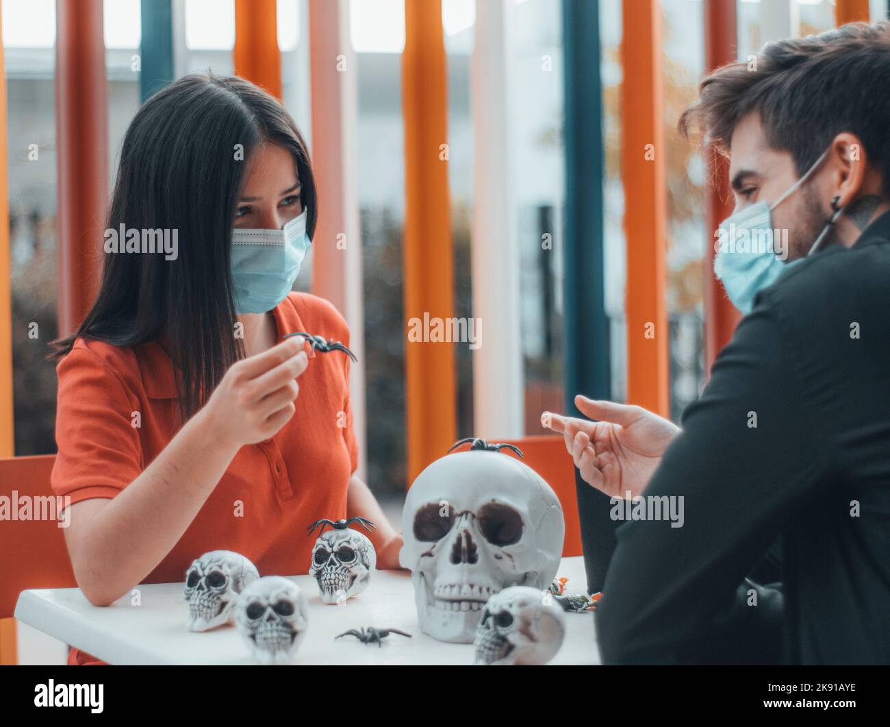 The people in masks talking about skull and bat halloween toy ...