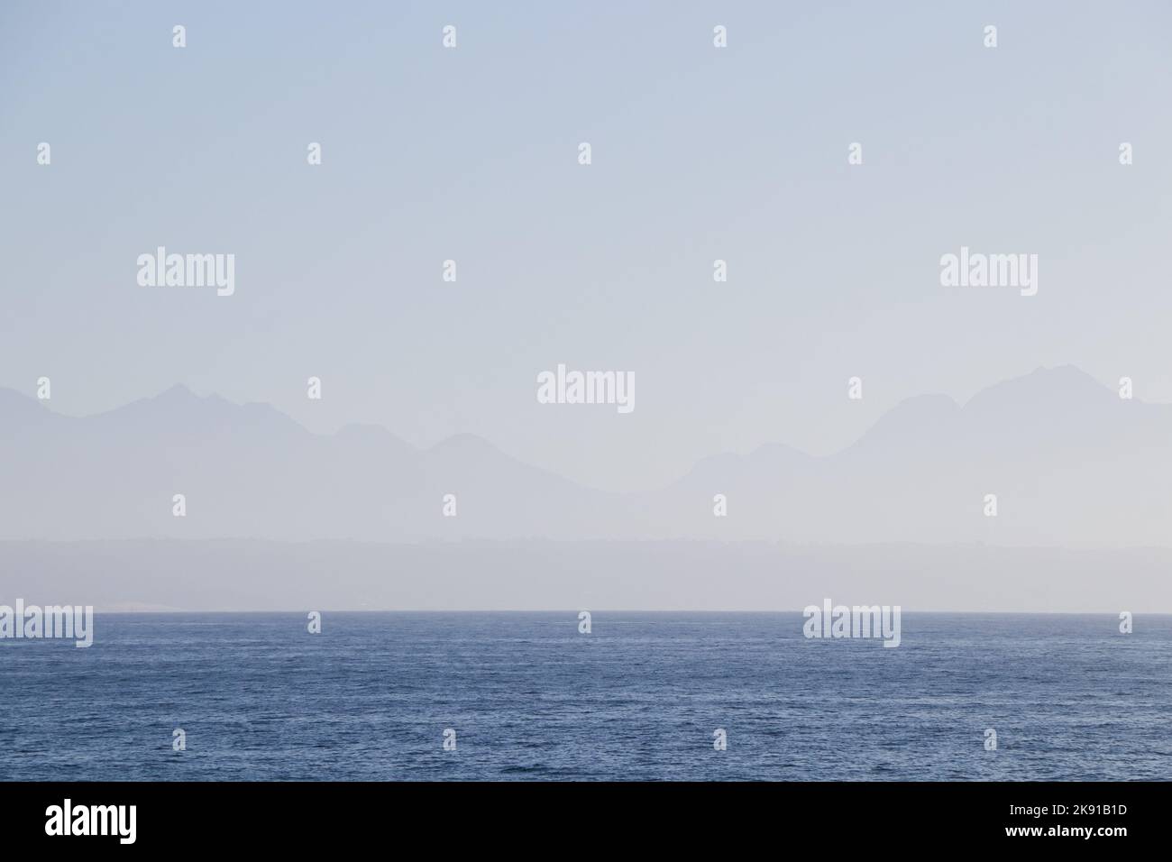 Seascape Horizon With Mountain Range In The Distance Stock Photo - Alamy