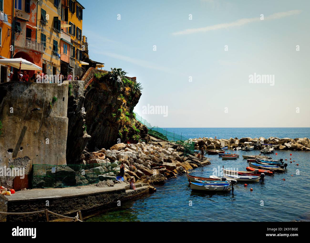 A scenic shot of sailboats on the shore of the Cinque Terre island in ...