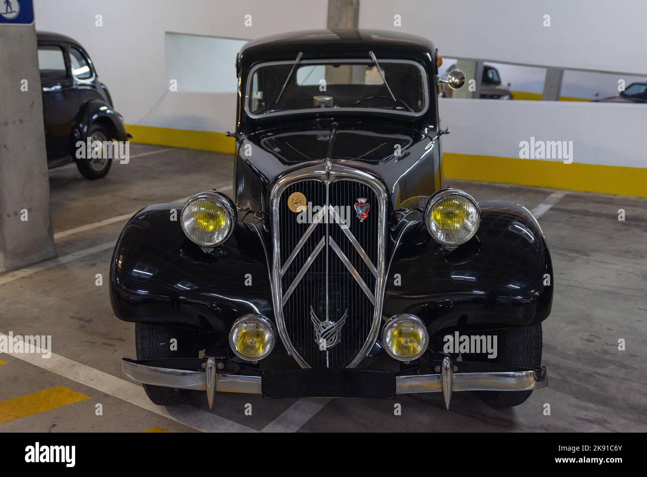A closeup of the front view of a black vintage Citroen model Traction ...