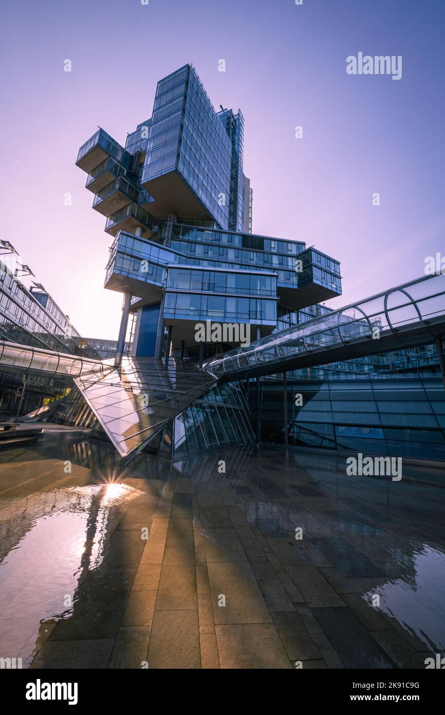A vertical low angle shot of the modern Nord LB Building with a water ...