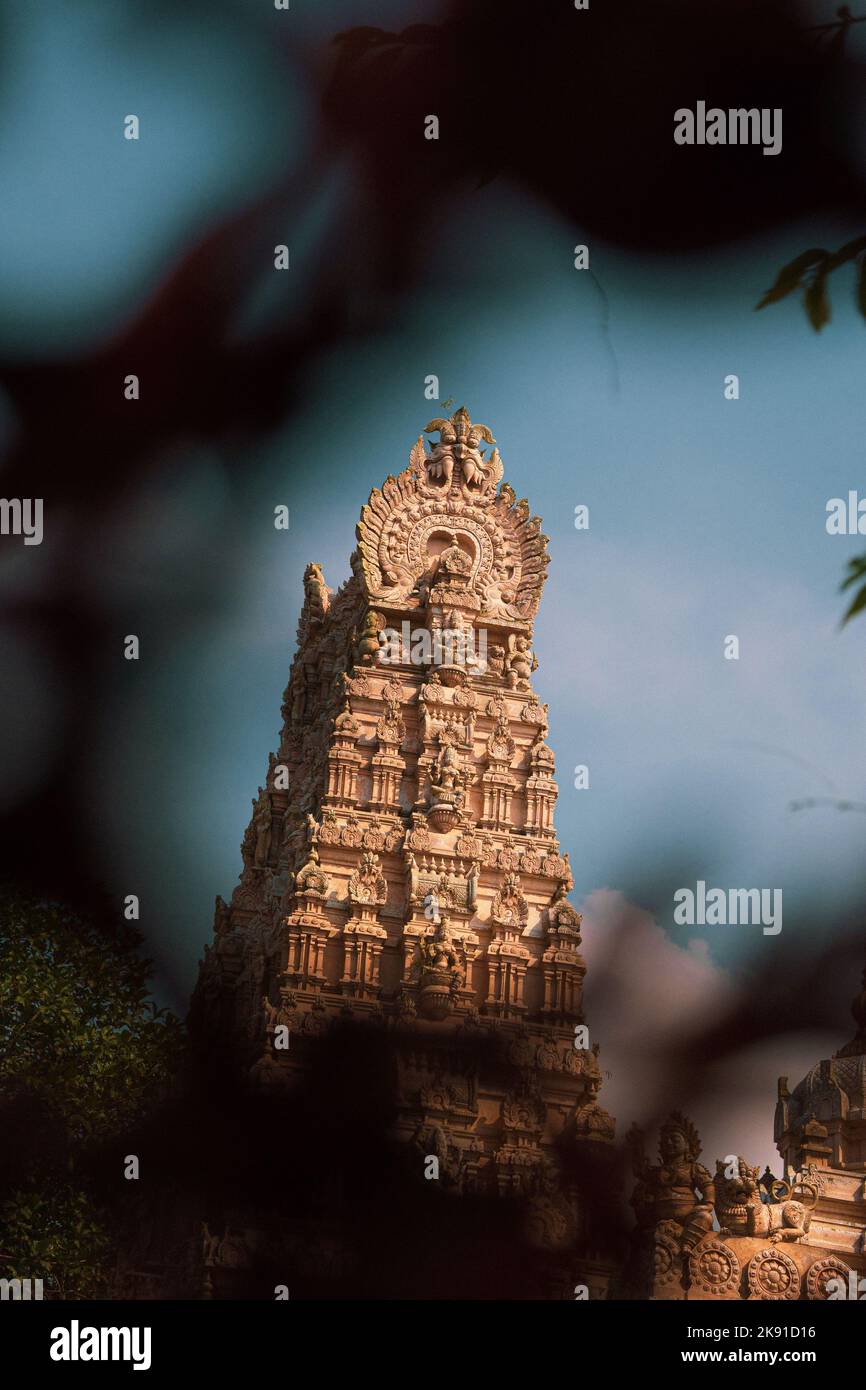The Sri Shakti Temple seen through leaves Stock Photo - Alamy
