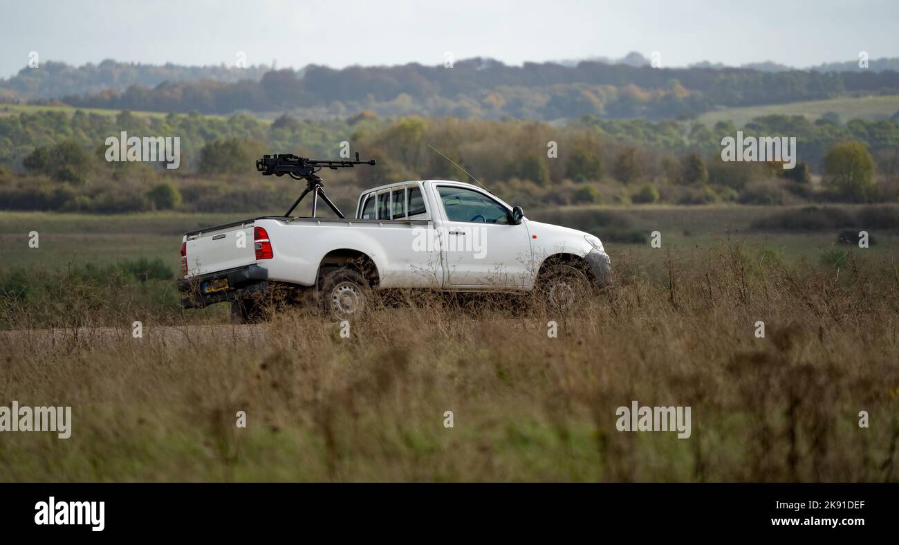 white toyota hilux pickup truck converted with an army large calibre ...