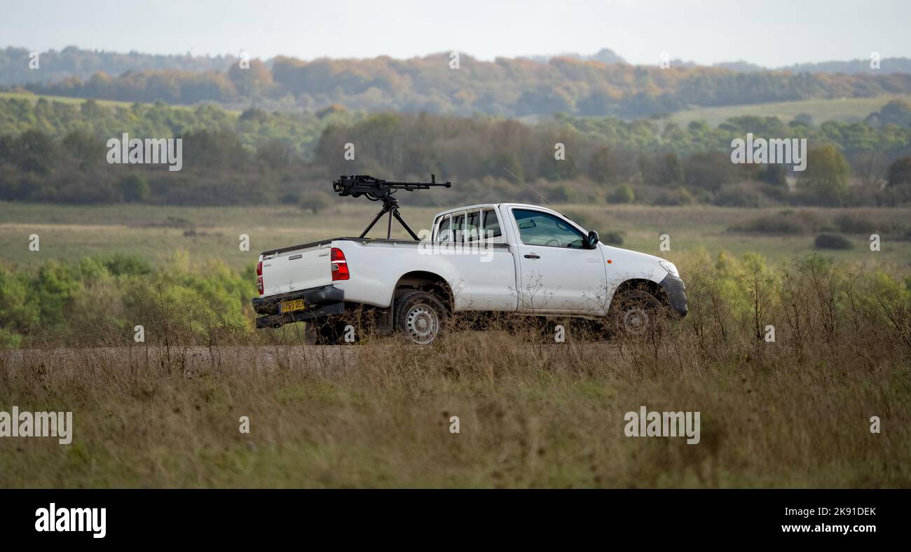 white toyota hilux pickup truck converted with an army large calibre ...