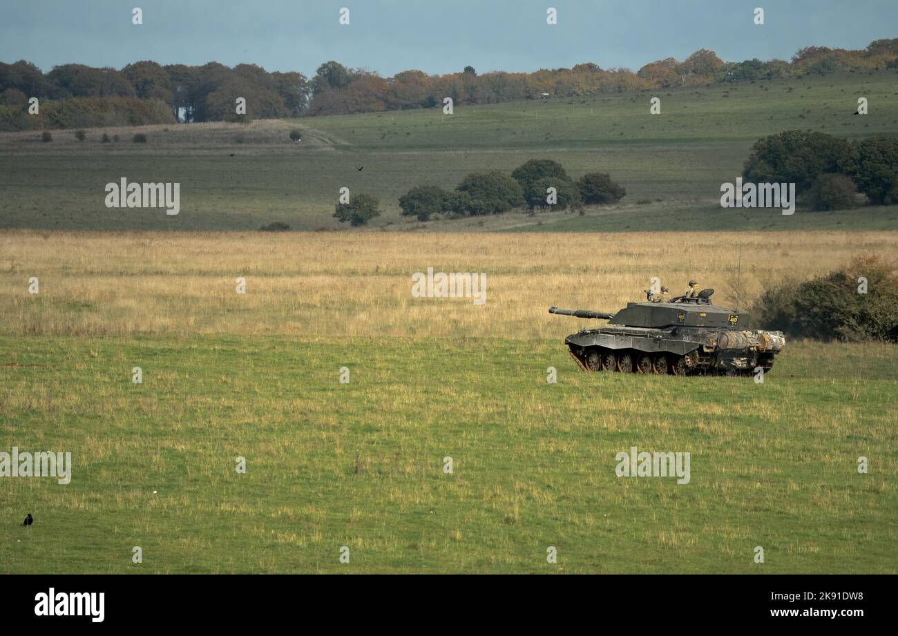 British army Challenger II 2 FV4034 main battle tank in action crossing open grass fields, on a ...
