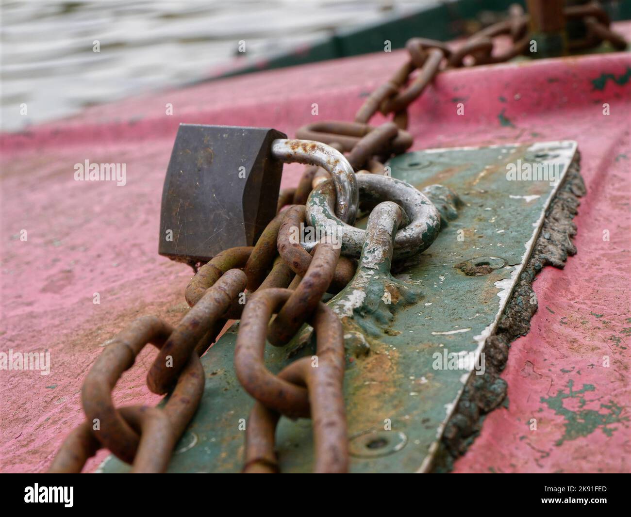 A closeup of an old rusty hingled lock on a chain Stock Photo - Alamy