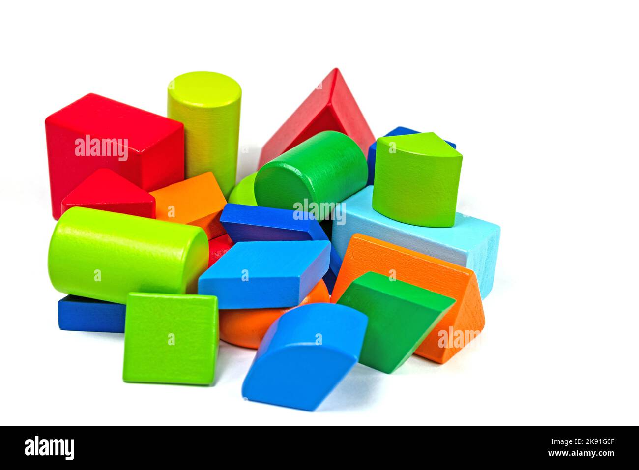 Wooden building blocks of different shapes and colors against a white ...