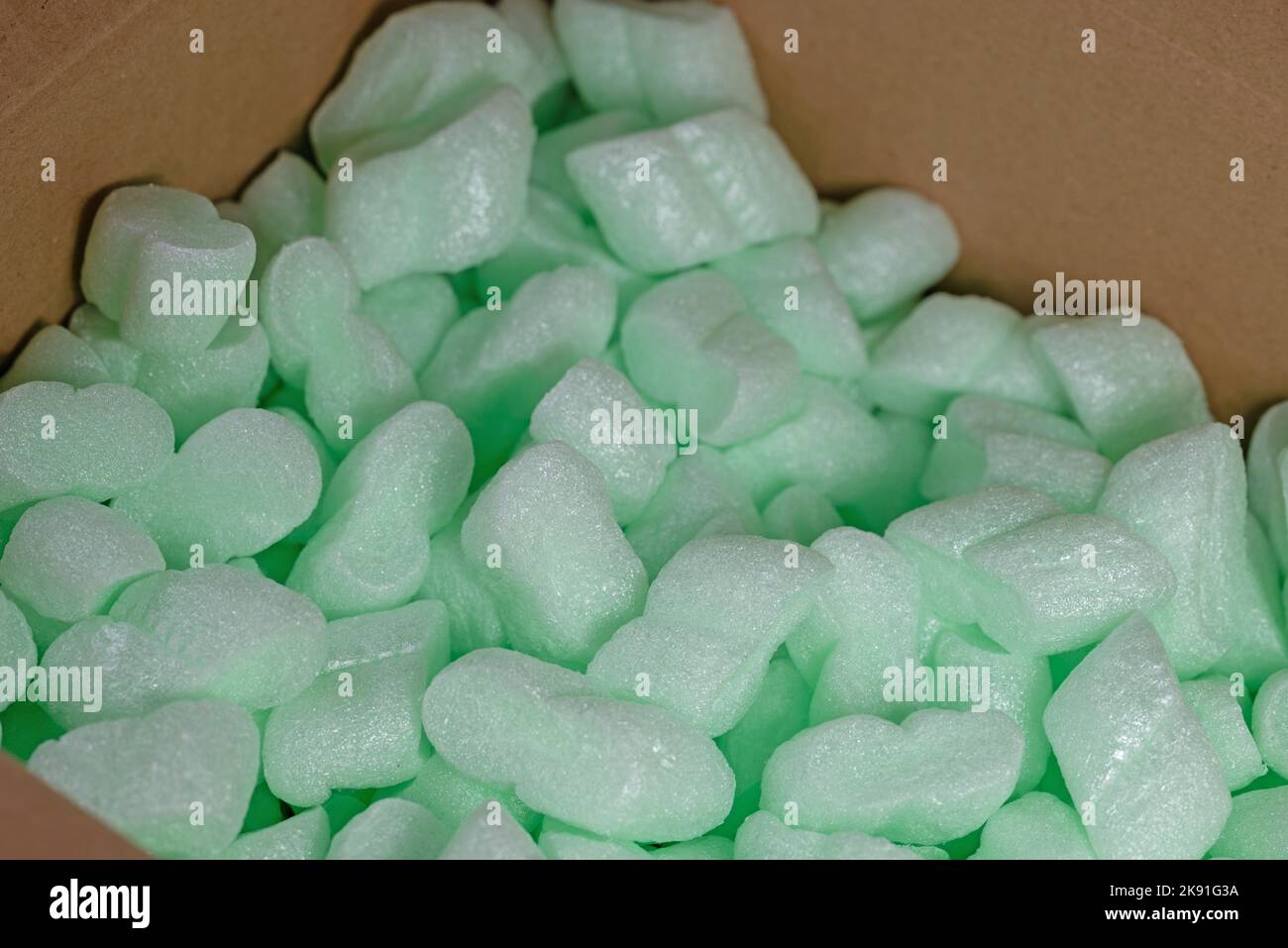 Packing chips, filling material in cardboard box Stock Photo - Alamy