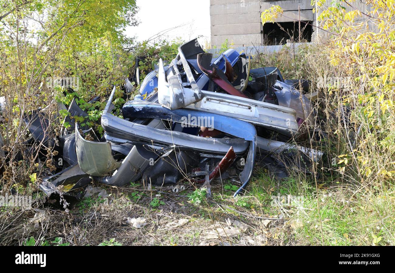 A pile of scrapped car bumpers. Land pollution with scrap metal ...