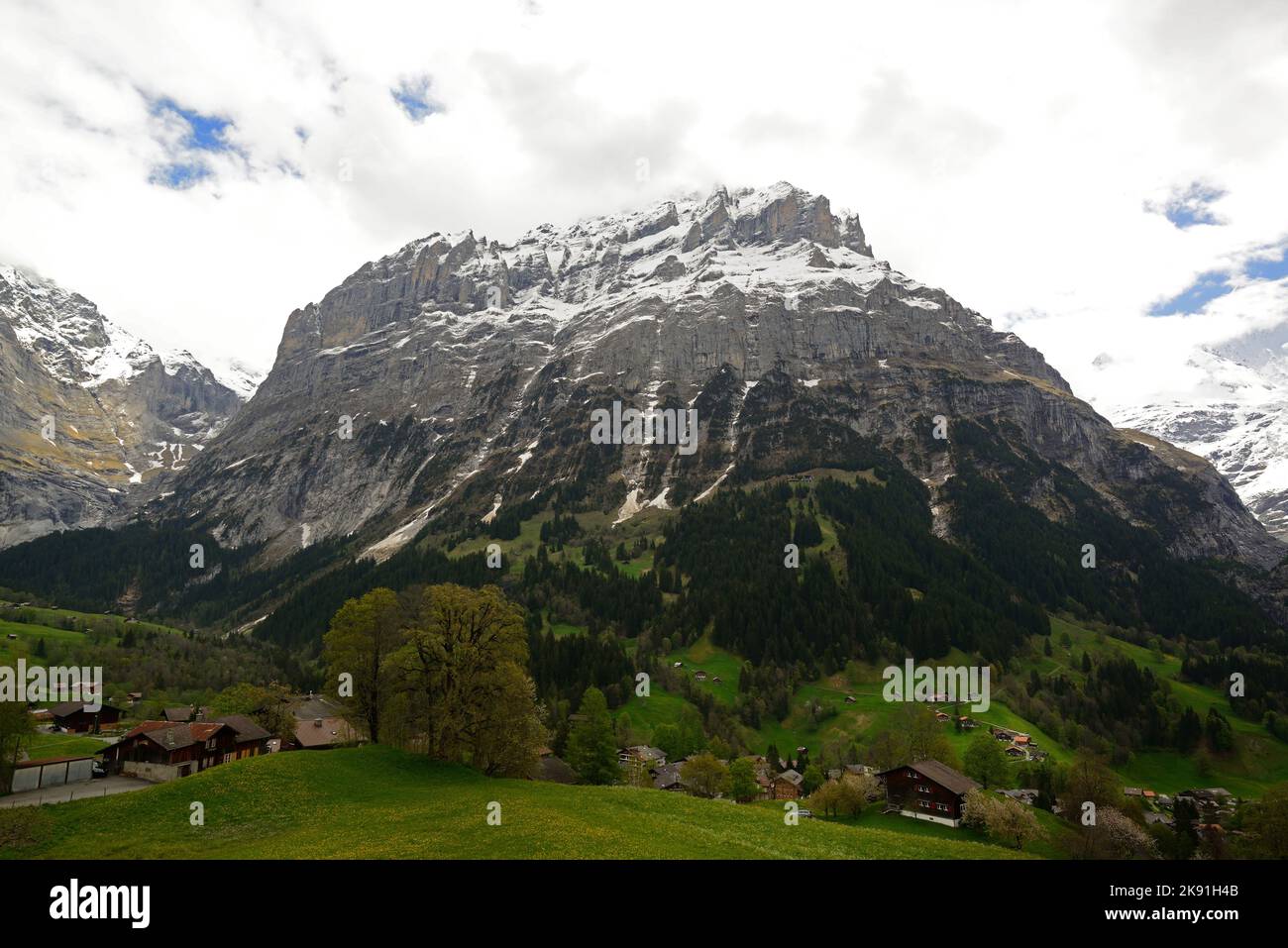 A scenic view of rural houses on a slope of snowy mountain in ...