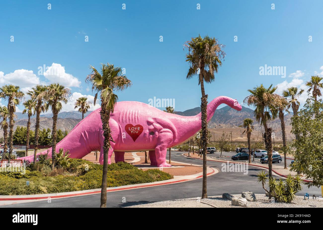 The life-sized pink Brontosaurus Dinosaur statue on a bright sunny day ...