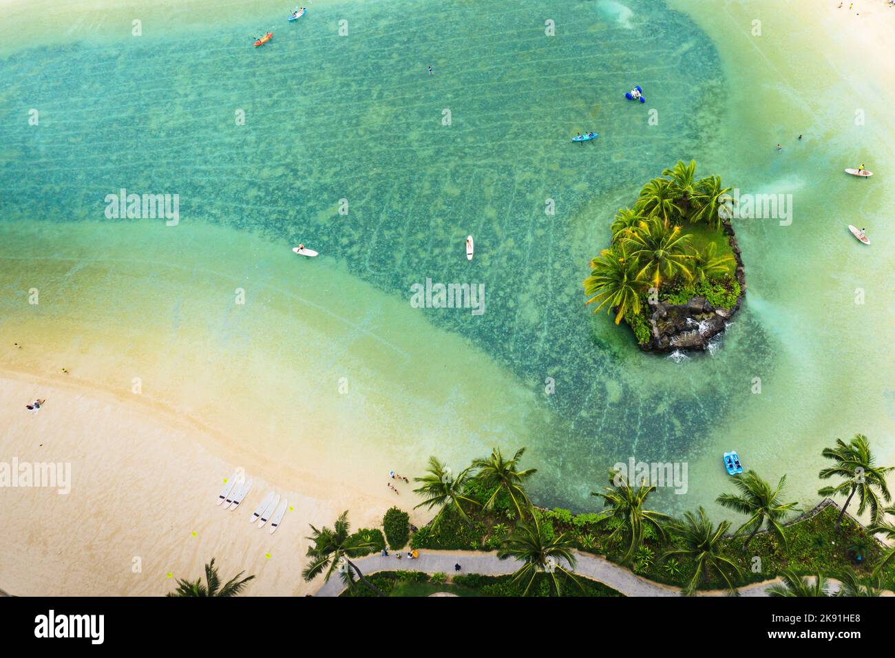 Areal view of little island filled with palm trees in a lagoon with ...