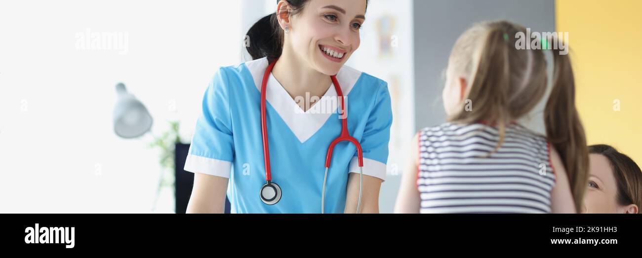 Pretty pediatrician chatting with cute patient child girl on ...