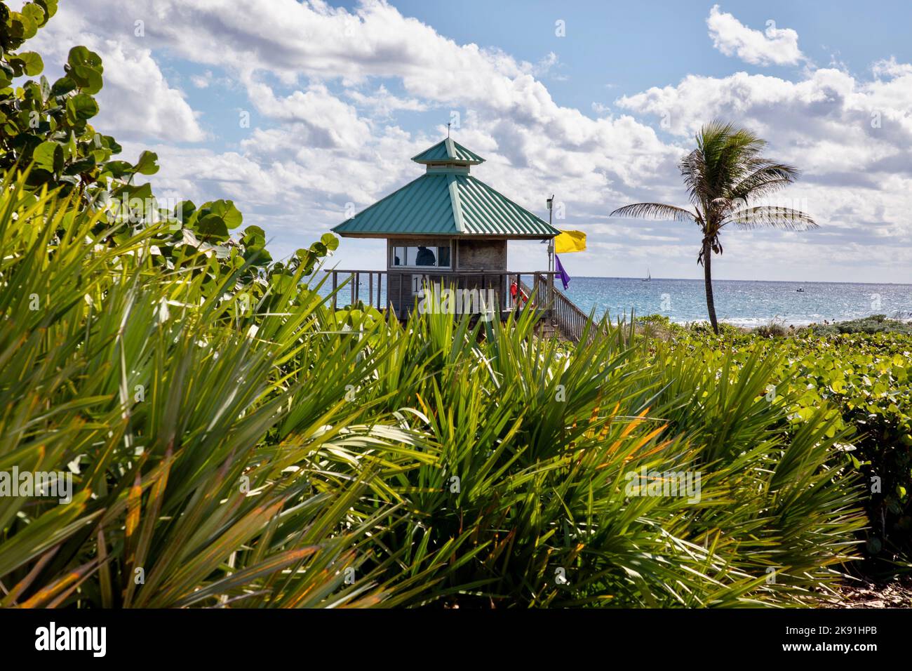 A wooden lifeguard station on Boca Raton beach with warning flags ...