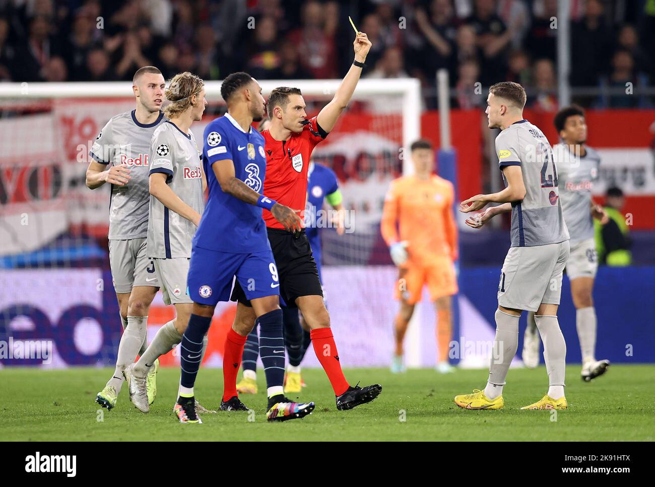 Referee Sandro Scharer shows a yellow card to RB Salzburg's Luka Sucic ...