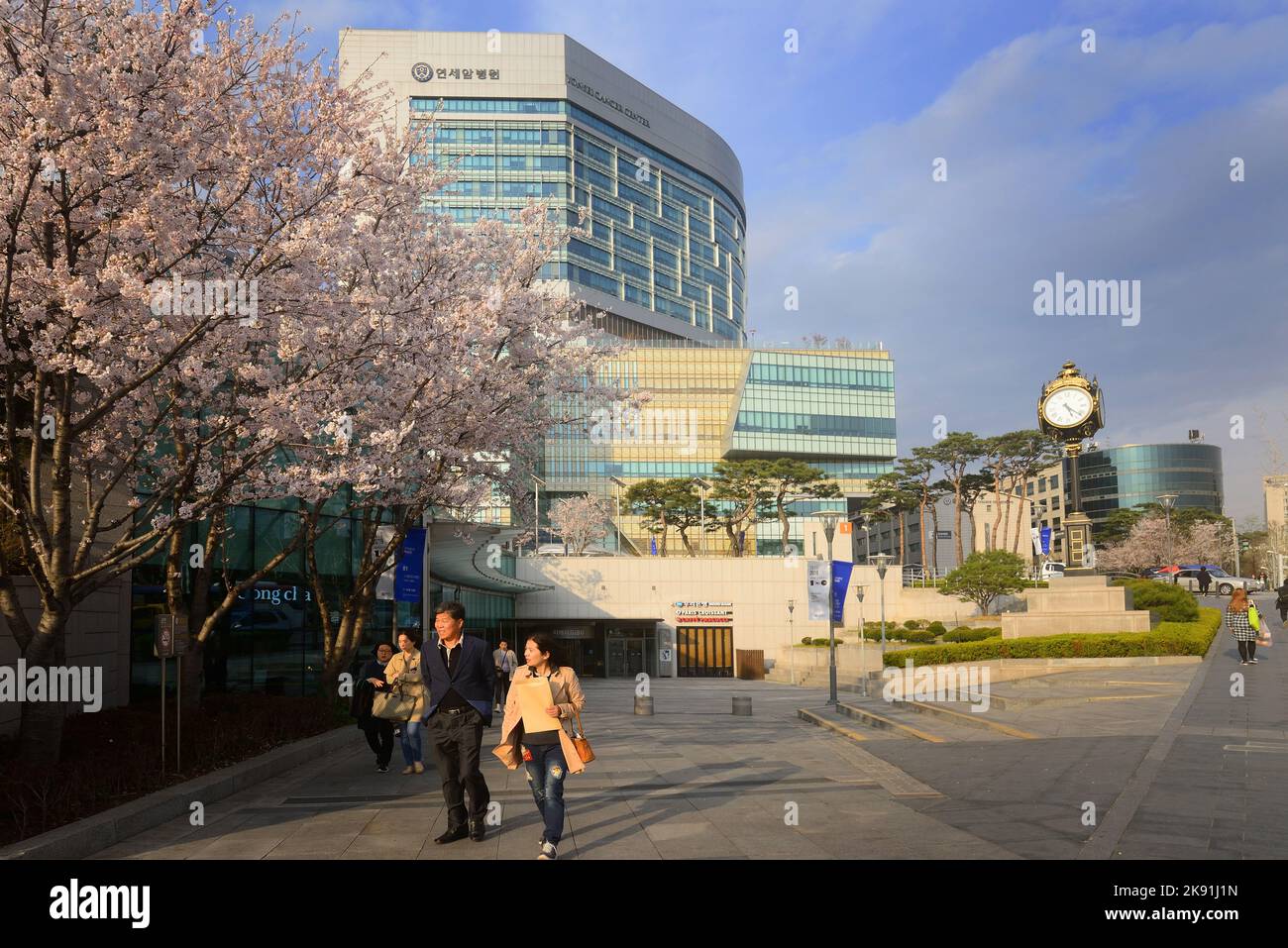 A low-angle of a spring street scene in Seoul with passers-by ...