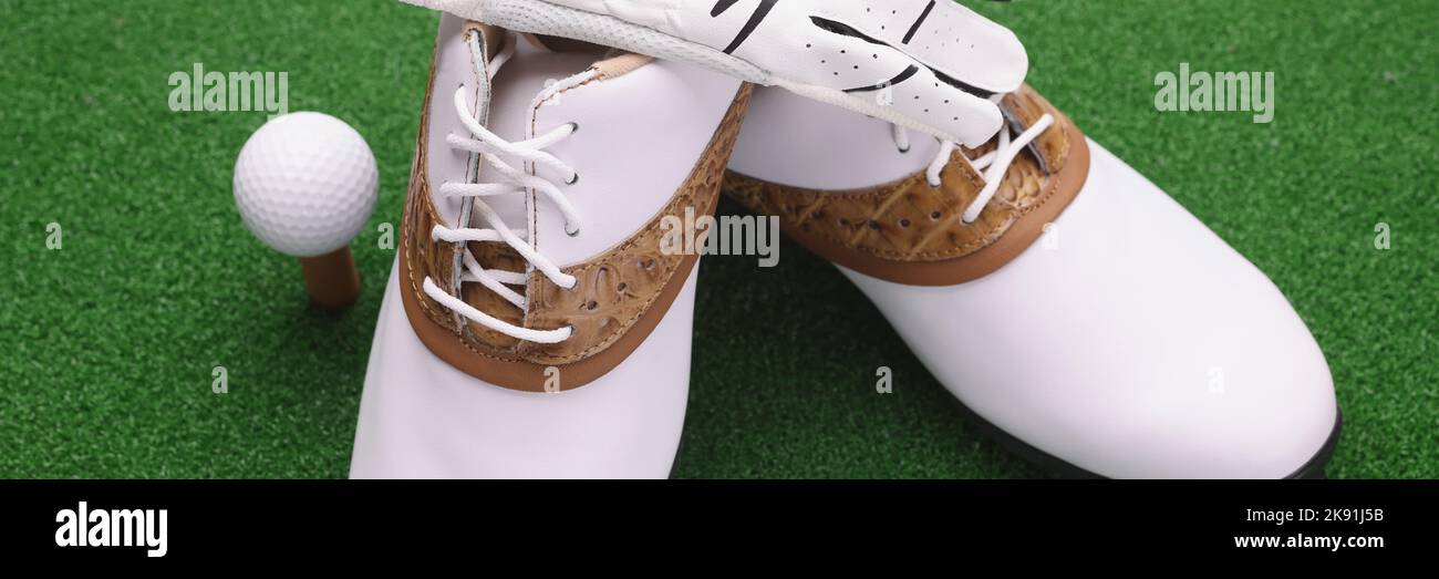 Golf set, stylish white leather boots with brown golf inserts, ball and ...