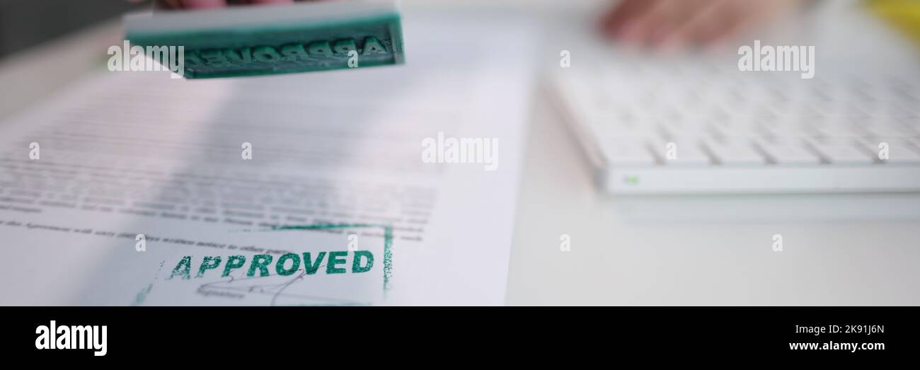 Green approved stamp on document, certificate contract, agreement ...