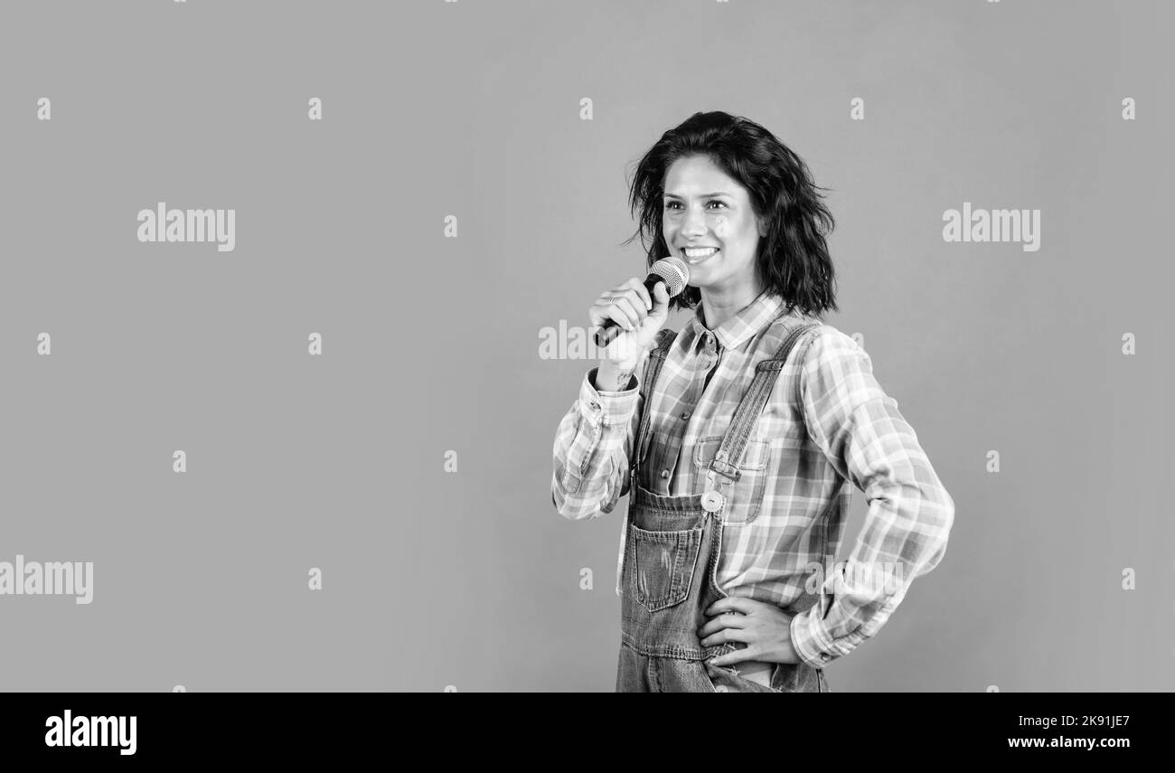 attractive beauty with mic. express human emotions. female singing to ...