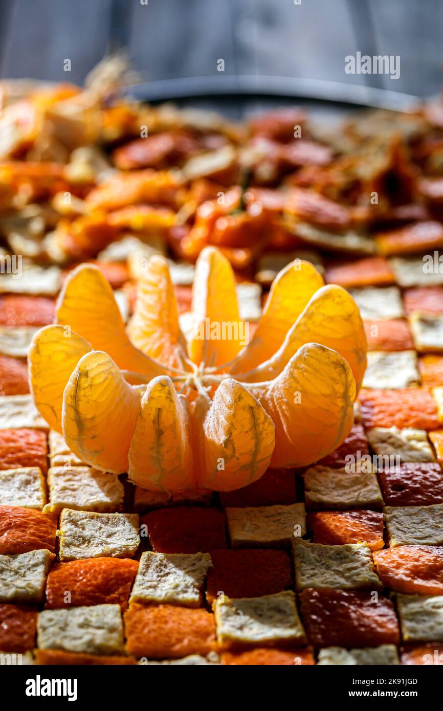 orange mandarin slices over the peel in squares Stock Photo - Alamy