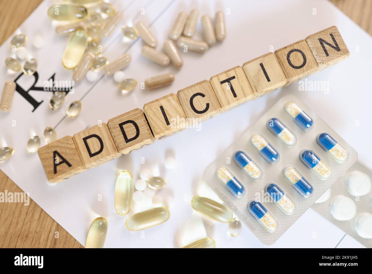 Word addiction collected with wooden cubes on white paper with ...