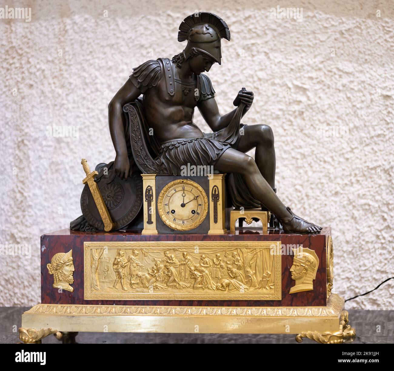 An old neoclassical marble and bronze mantel clock with a figure in ...