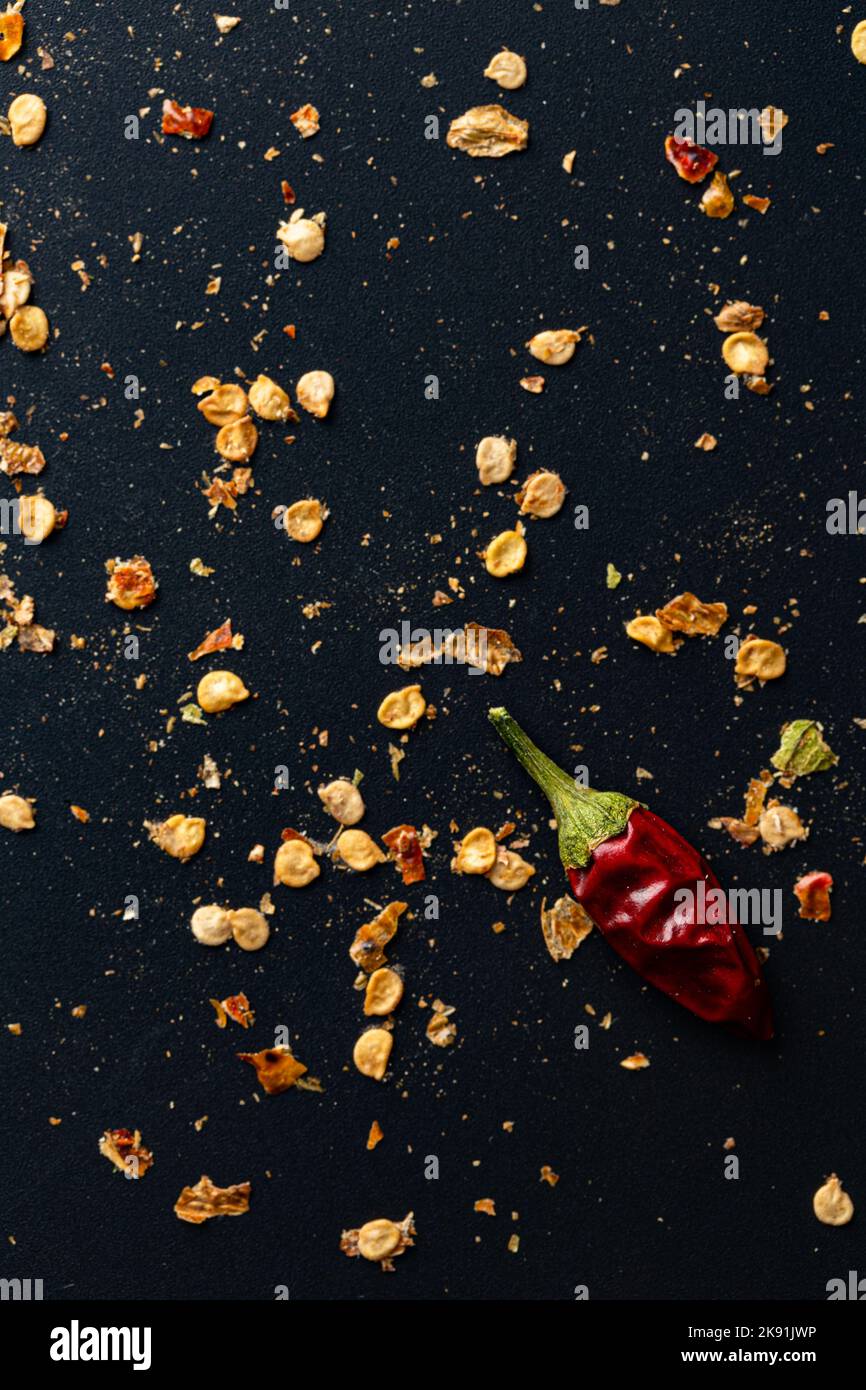 hot red chilli seeds on black background Stock Photo - Alamy