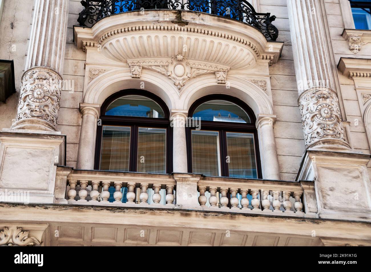 Carved fluted columns and corbeled curved balcony in Vienna, Austria ...