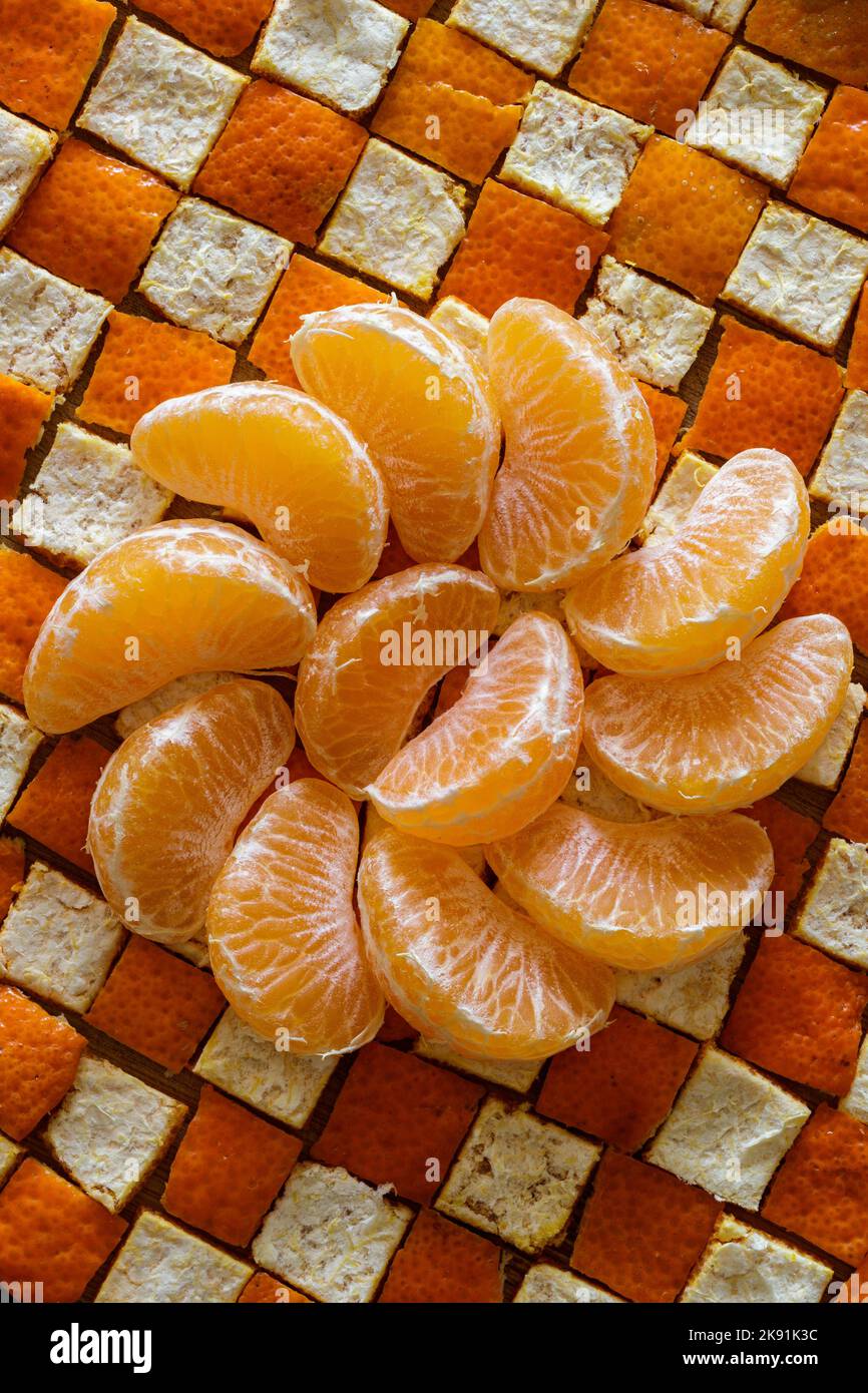 orange mandarin slices over the peel in squares Stock Photo - Alamy