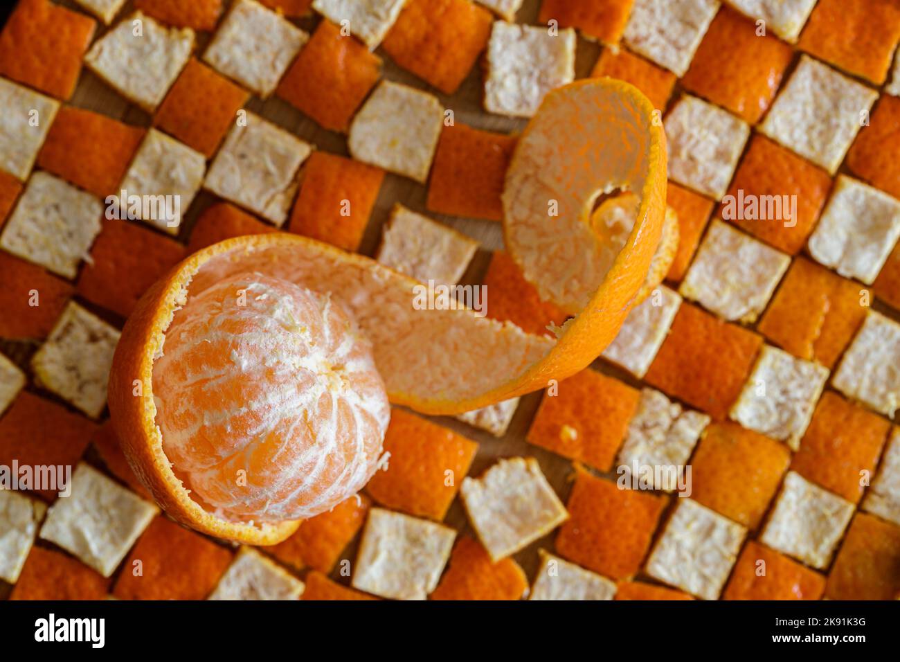 mandarin orange peeled in half on the peel in squares Stock Photo - Alamy