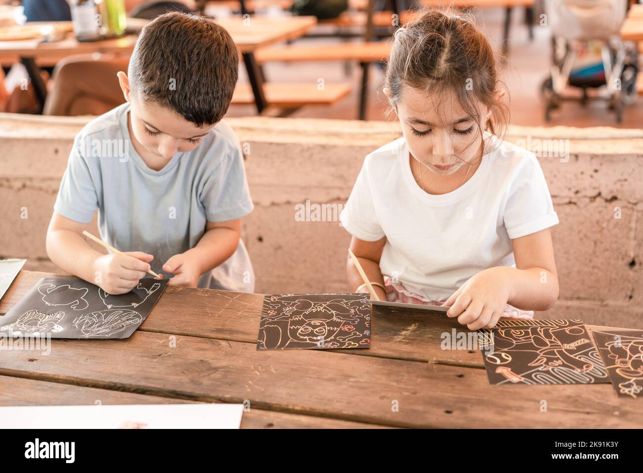 Little children draws scratches at a school yard Stock Photo - Alamy