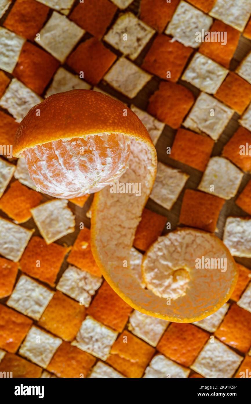mandarin orange peeled in half on the peel in squares Stock Photo - Alamy