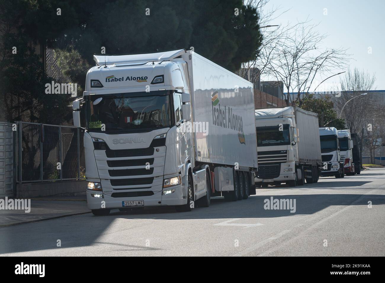 The Scania S 450 truck with lights on driving down the street Stock ...