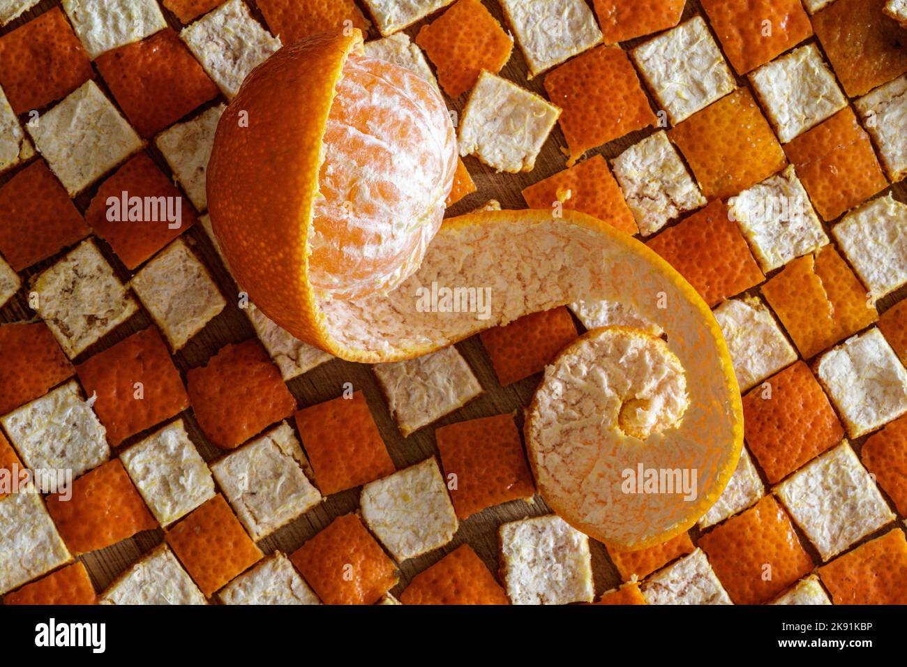 mandarin orange peeled in half on the peel in squares Stock Photo - Alamy
